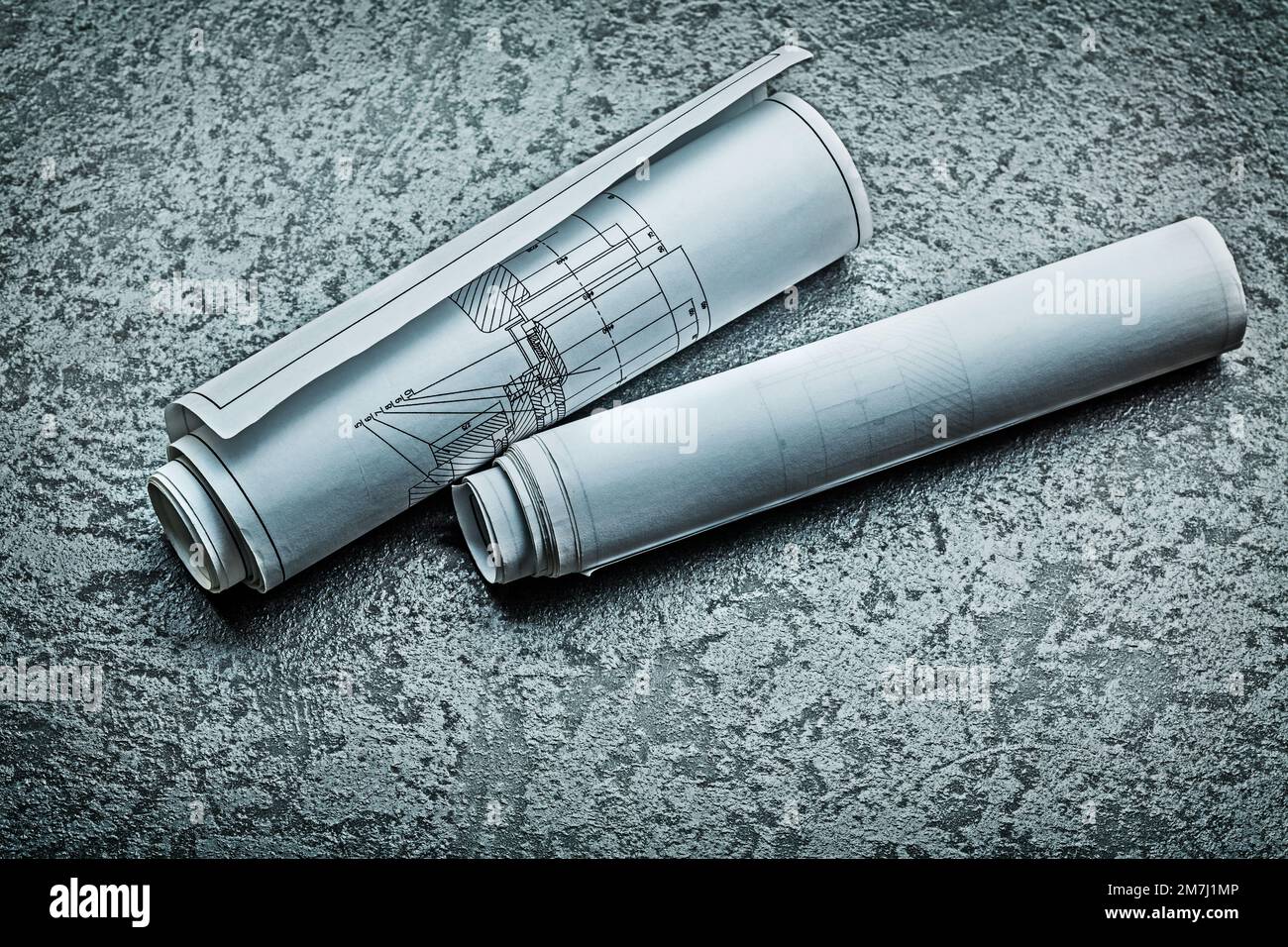 two rooled up blueprints on black background Stock Photo - Alamy