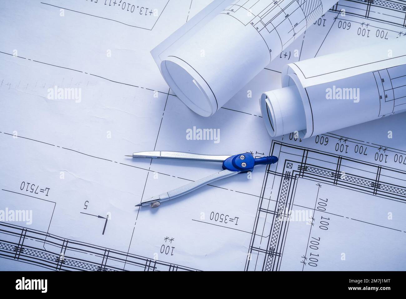 vertical version compass and rolled blueprints close up Stock Photo - Alamy