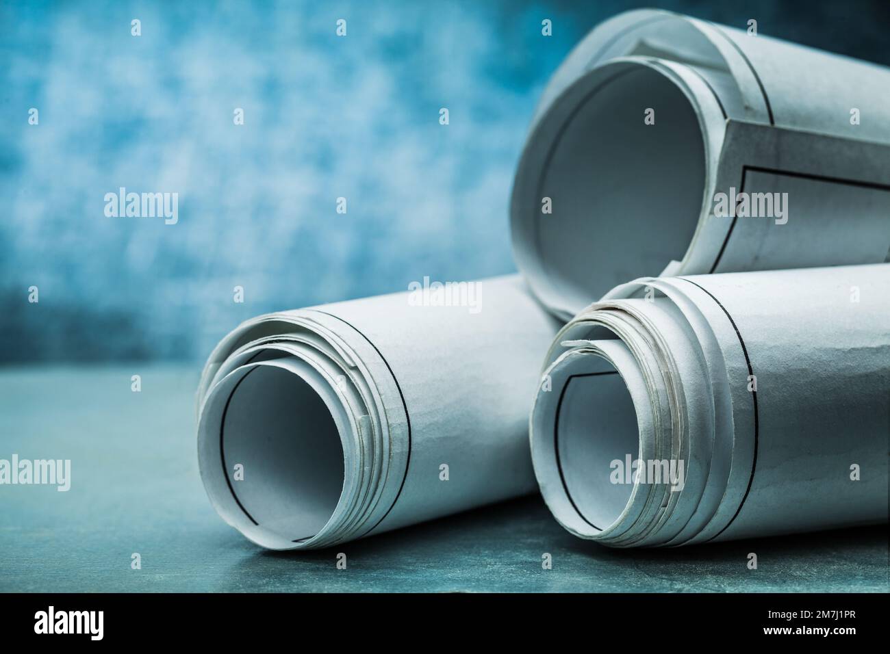 very close up view on roled blueprint metalic background Stock Photo ...
