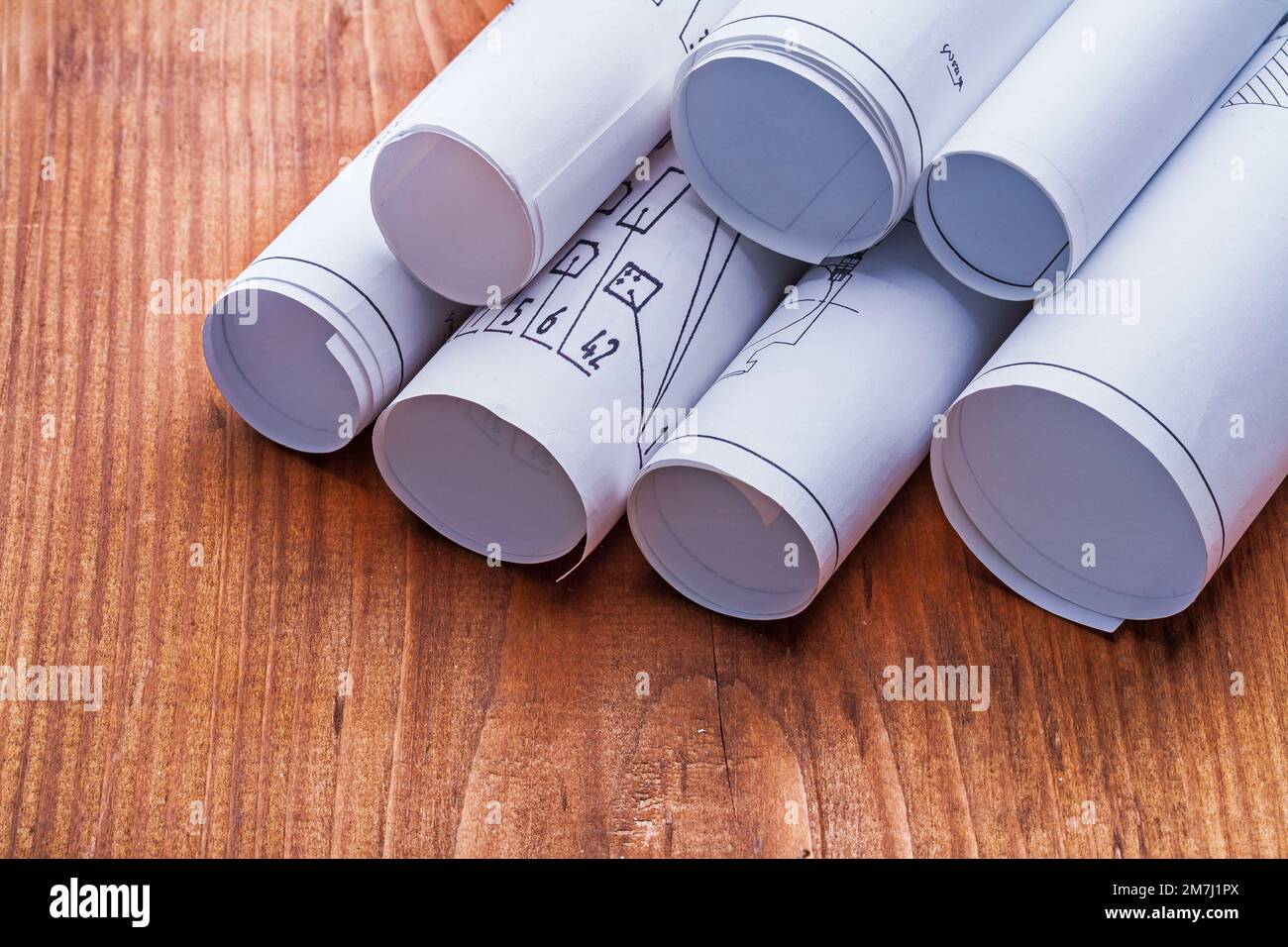 very close up view on stack of blueprints on old wooden board Stock ...
