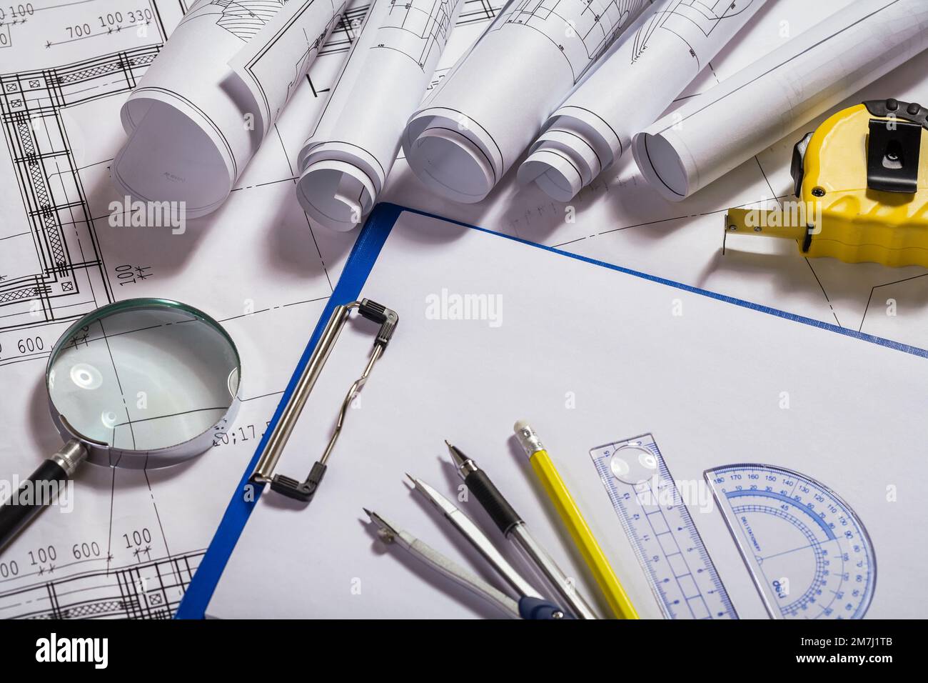 Wiew on a typical engineer workplace with blueprint and measuring tools ...