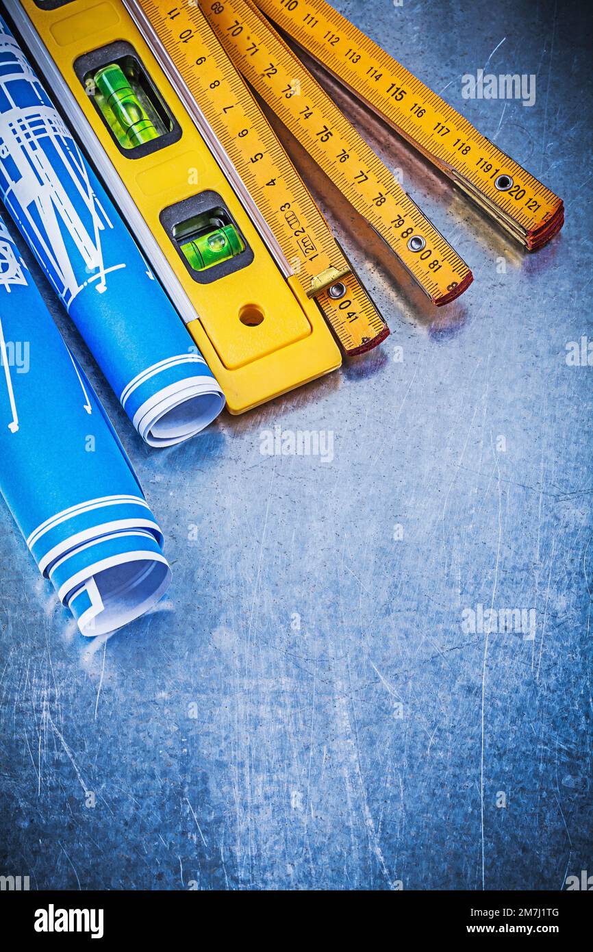 Wooden meter blue construction plans level on metallic background Stock ...