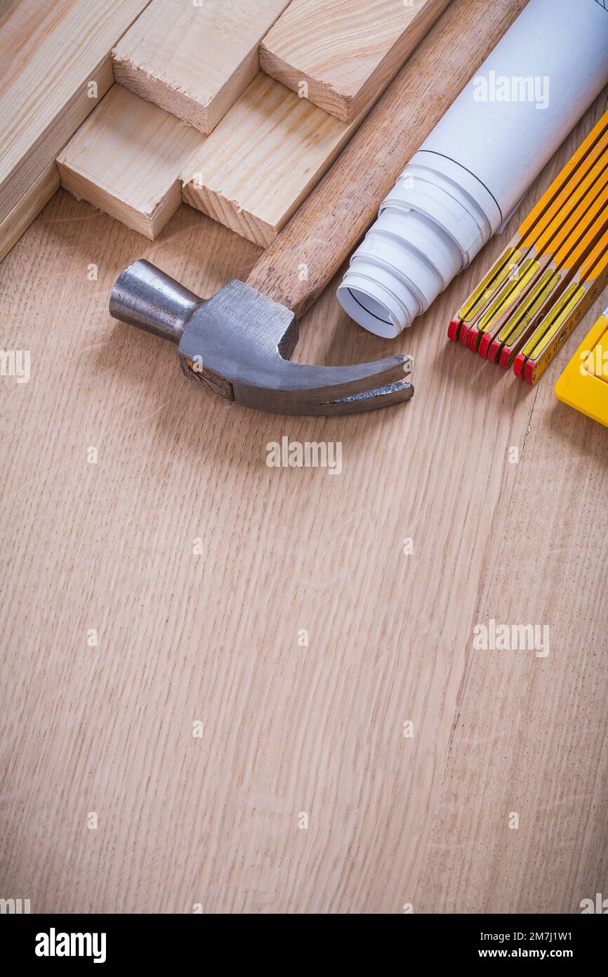 Wooden bricks and meter hammer construction plans on wood board ...