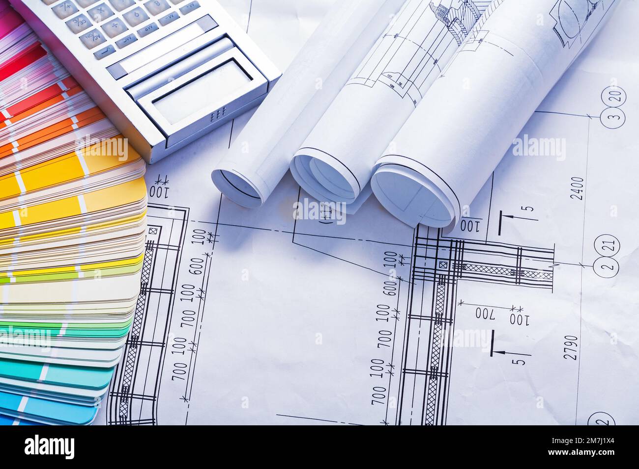 white rolled blueprints calculator and color palette construction ...
