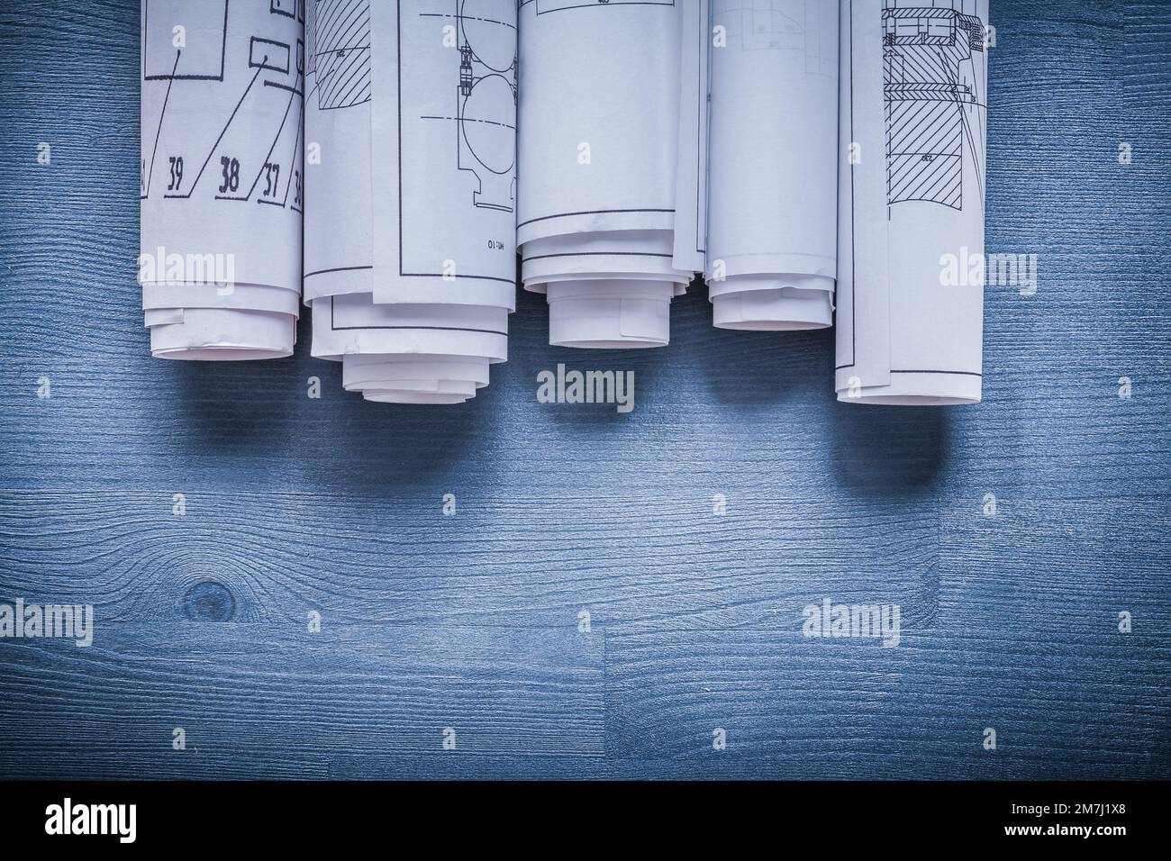 white rolls of blueprints on board Stock Photo - Alamy