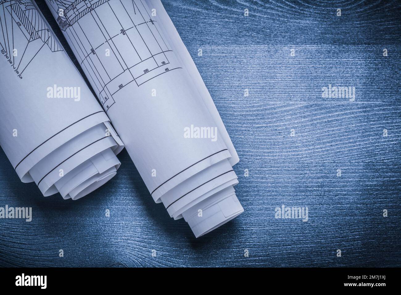 white rolled blueprints on painted board Stock Photo - Alamy
