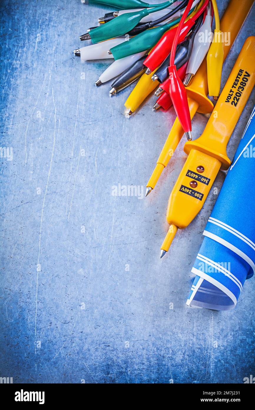 Yellow electrical tester crocodile cables set blue blueprints on ...