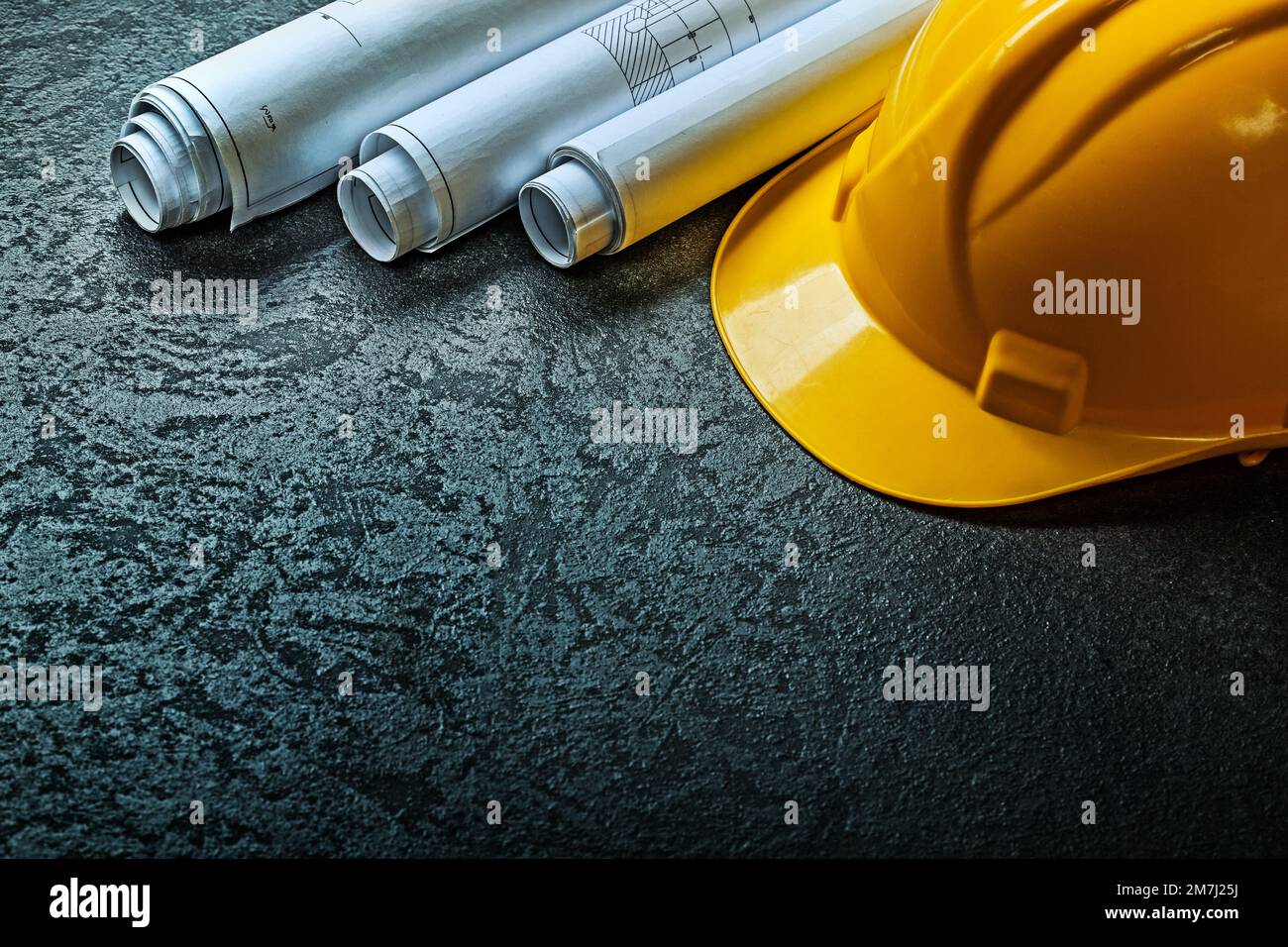 Yellow helmet rolled blueprints hi-res stock photography and images - Alamy