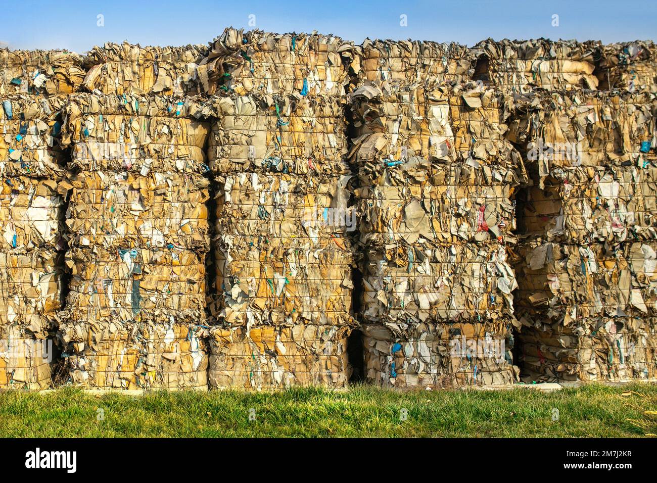 Large stacks waste paper for recycling on the grass outdoors Stock ...