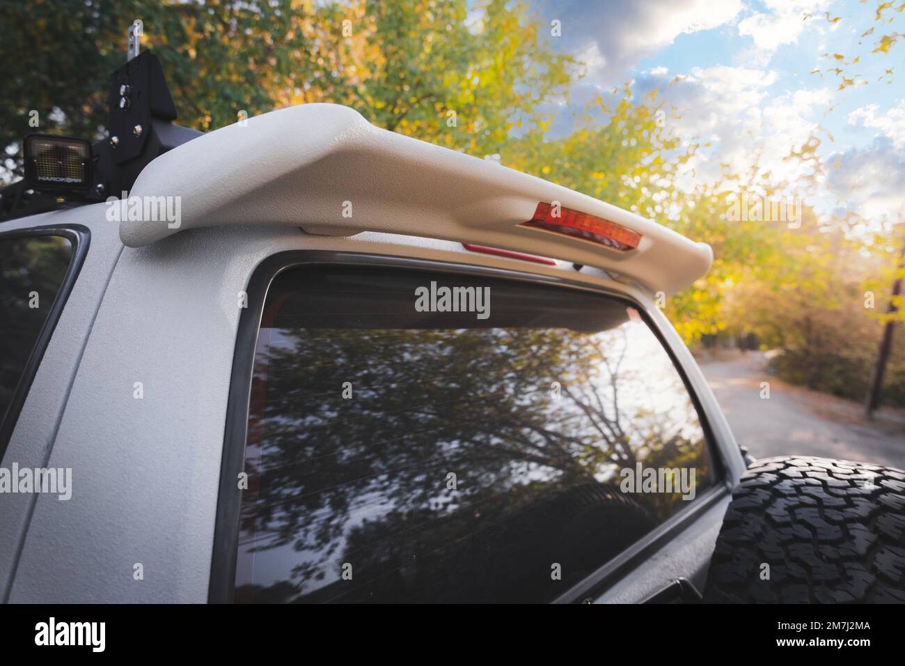 Rear view of a white suv with a spoiler outdoor Stock Photo - Alamy