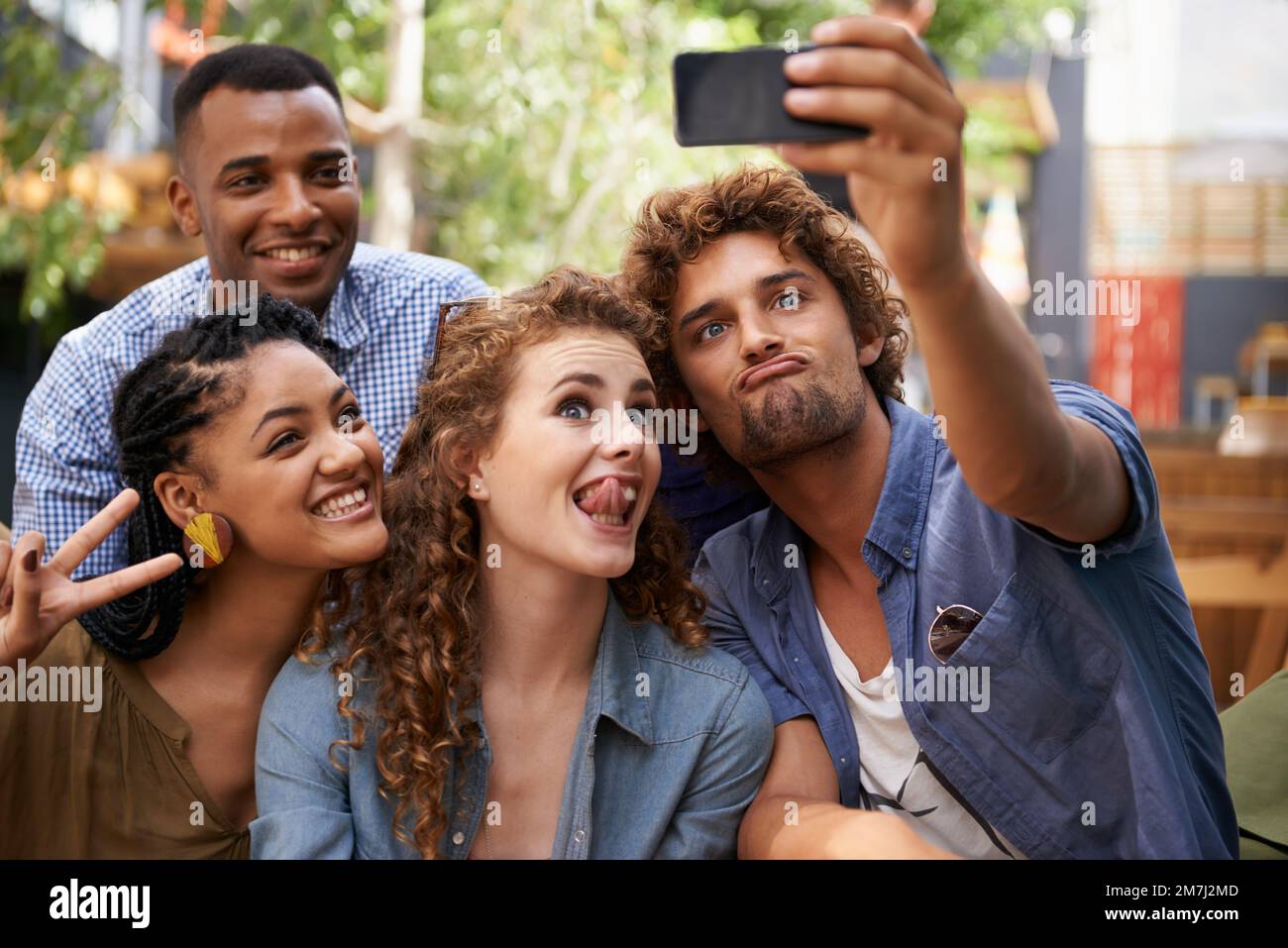 Capturing their moments of friendship. a group of friends taking a self-portrait on a ...