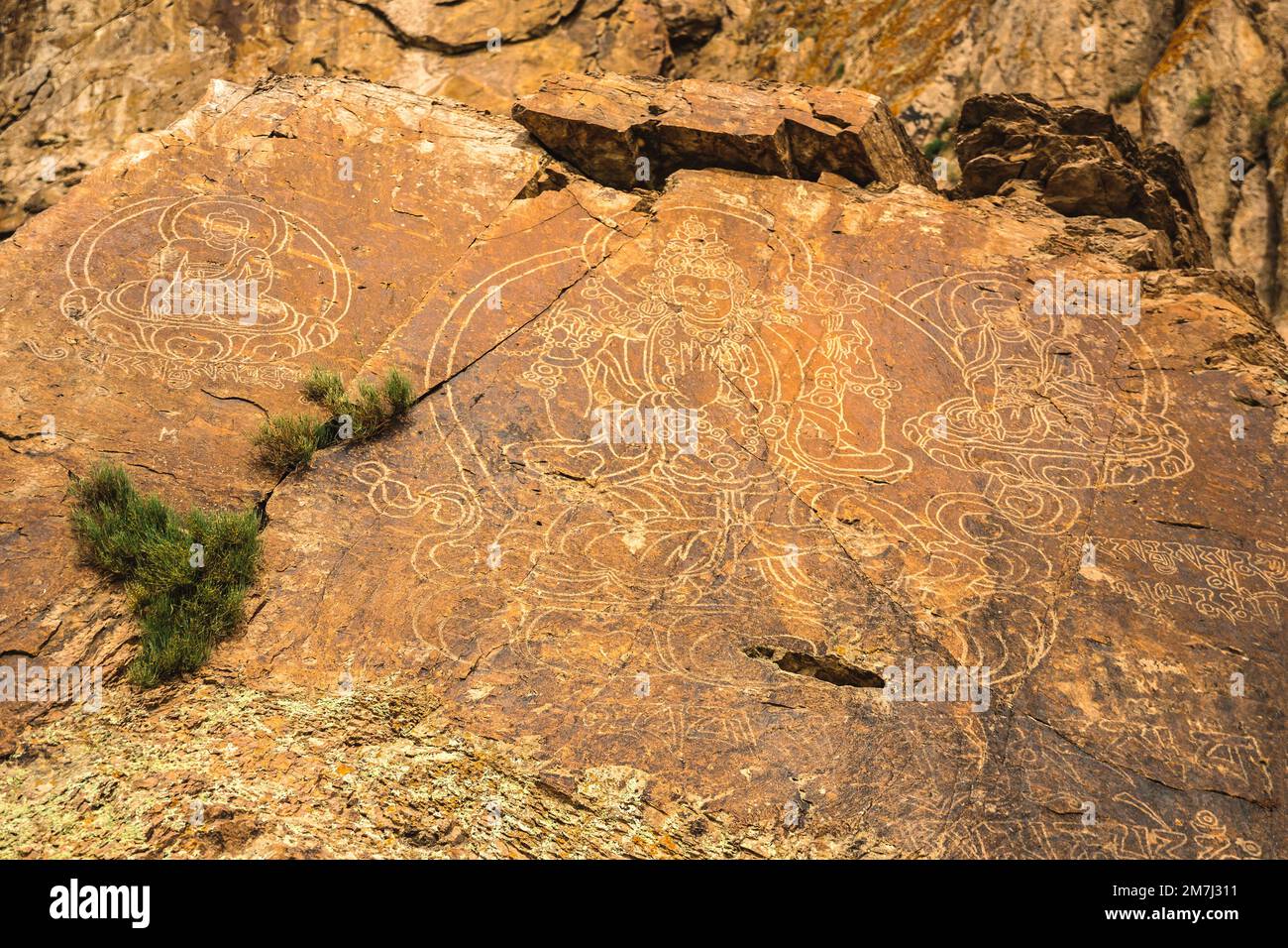 An ancient Buddha image on a stone rock. UNESCO World Heritage Site in ...