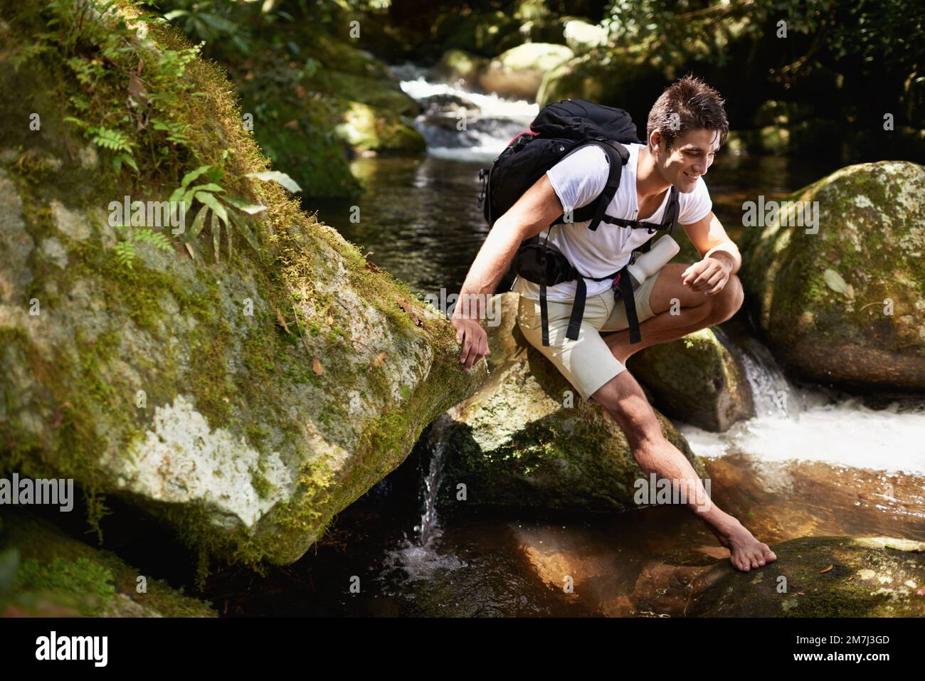 Enjoying the peace and tranquility of the forest. a handsome young man ...