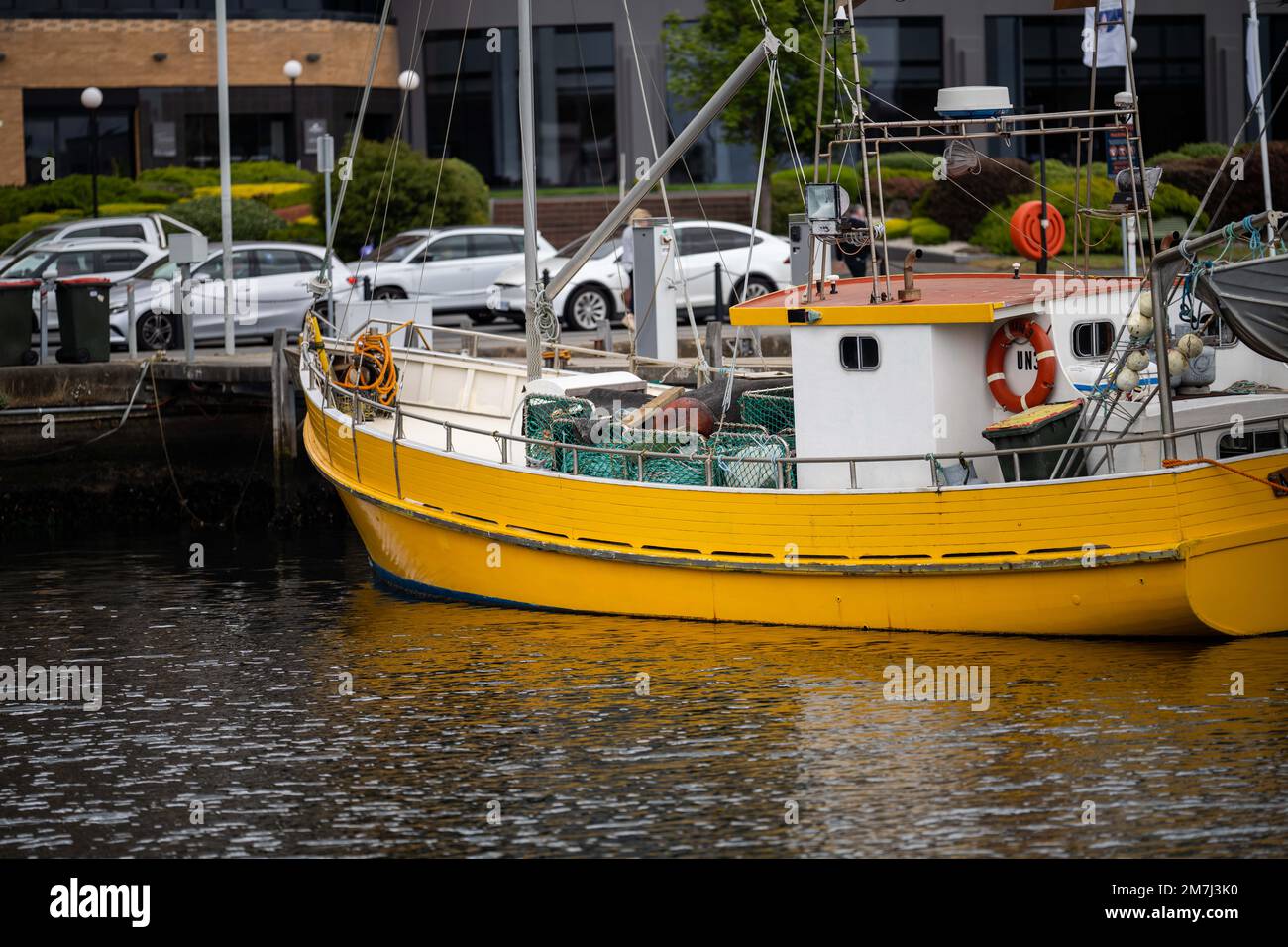 fishing boat moored to a buoy in a marina in spring in summer Stock ...