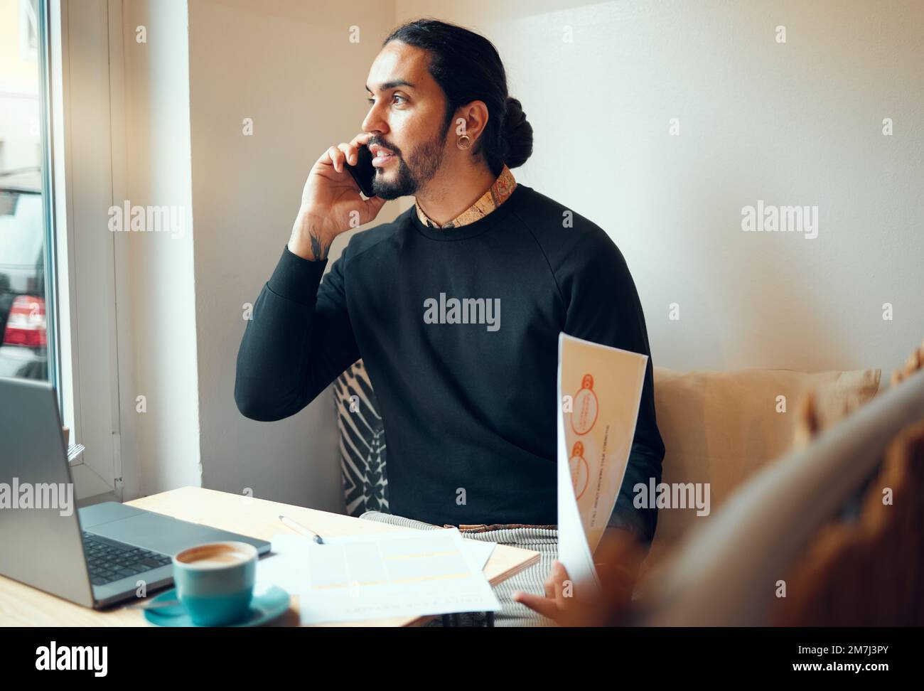 Home office, documents and phone call, freelancer man at desk consulting on smartphone with ...