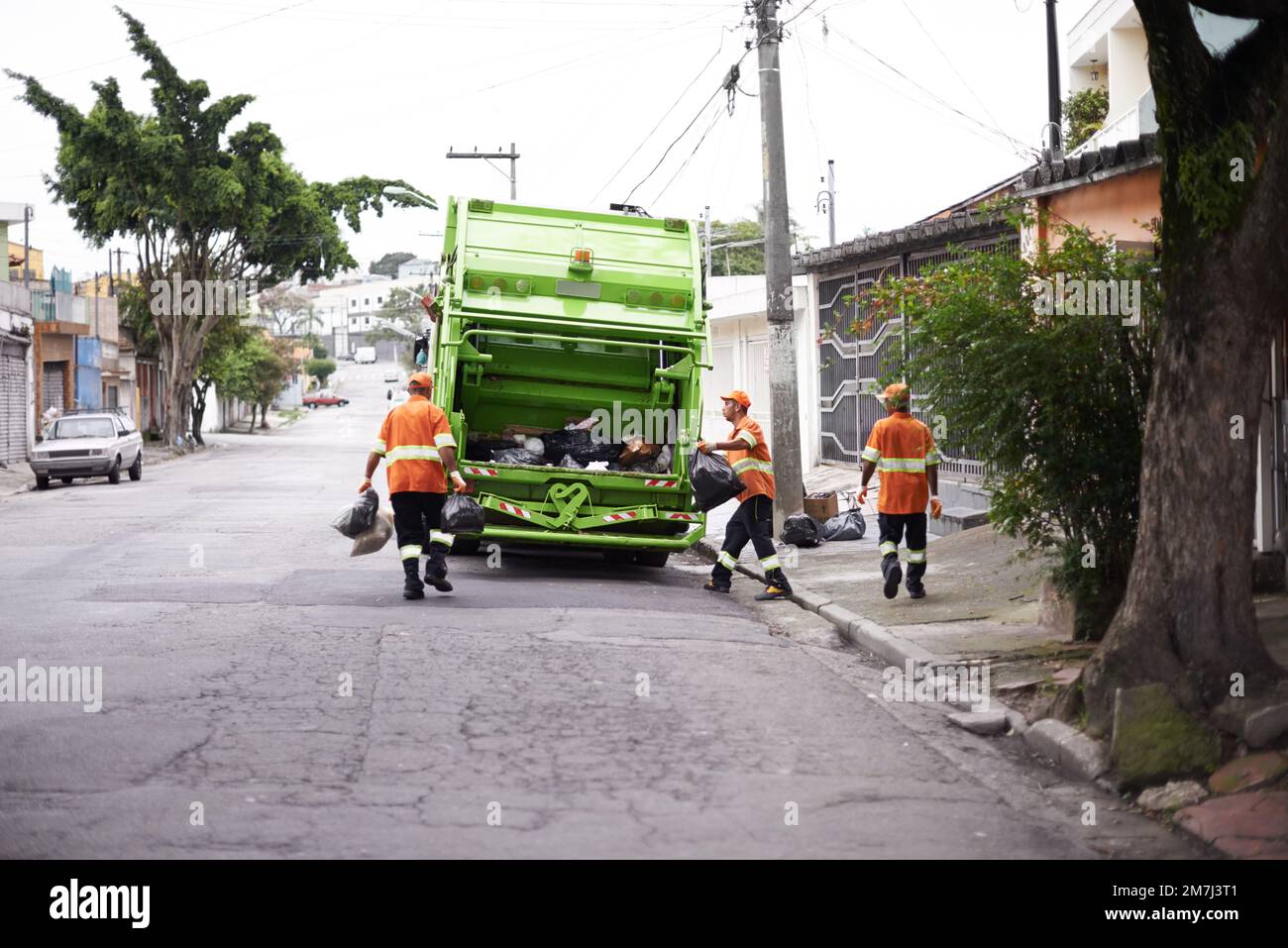 Garbage collection day. a garbage collection team at work Stock Photo ...