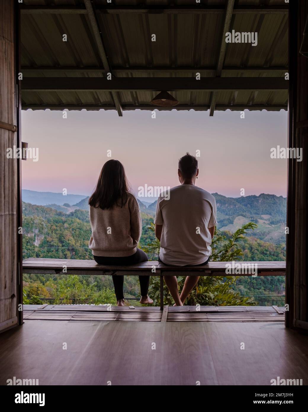 Couple watching the sunrise at Mae Hong Son mountains in Thailand, Ban ...