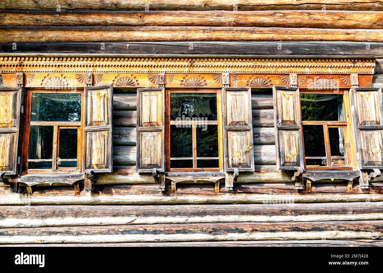 Windows of old traditional russian log house with carved wooden trim ...