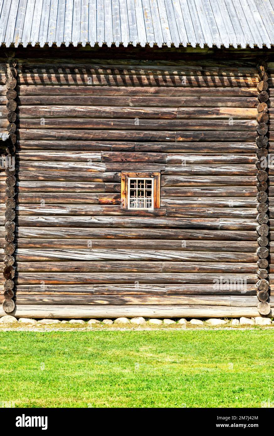 Small window in the wall of old wooden log house. Vintage wooden house ...