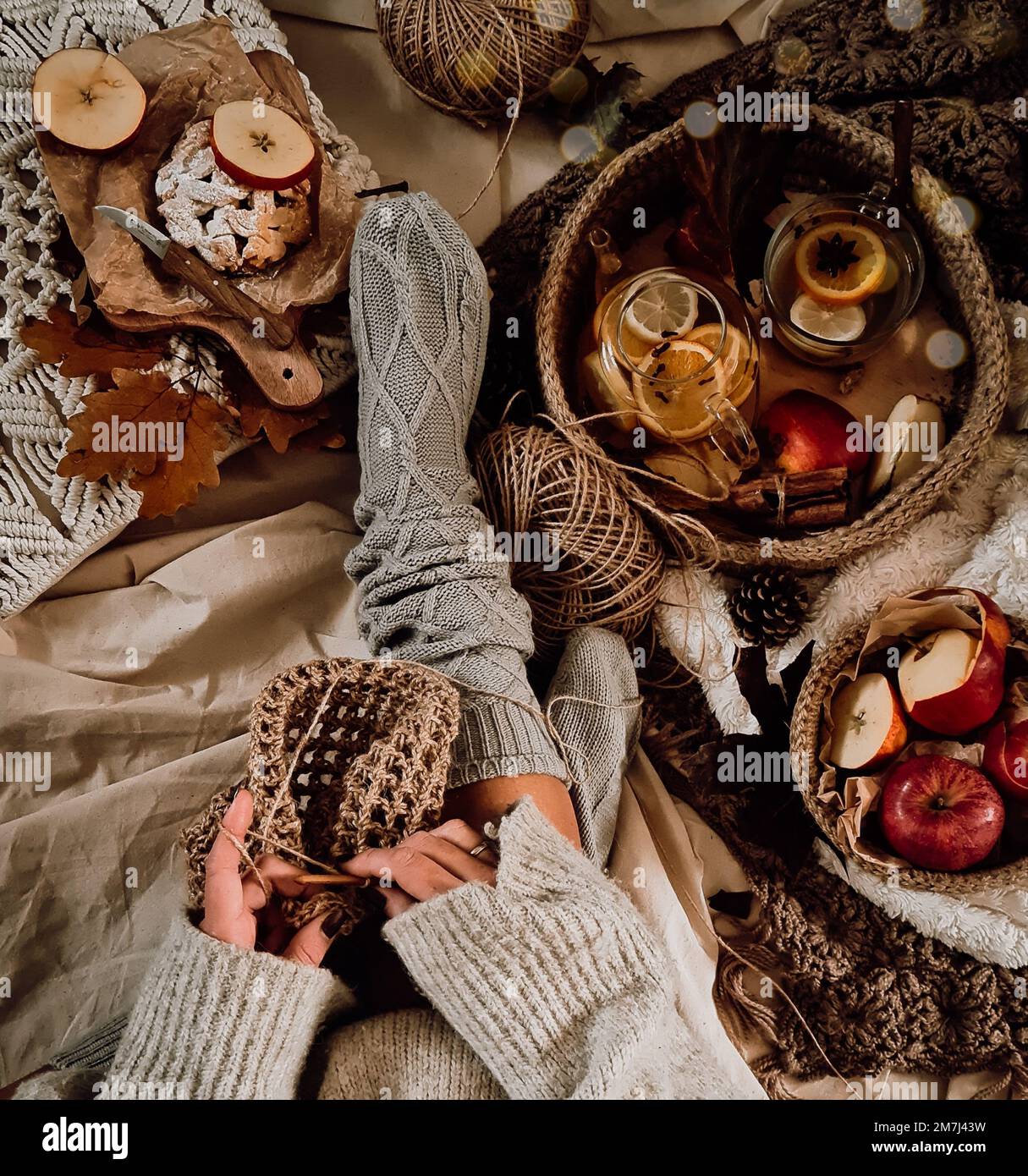 A vertical top view of a woman weaving sitting on her bed with a pie ...