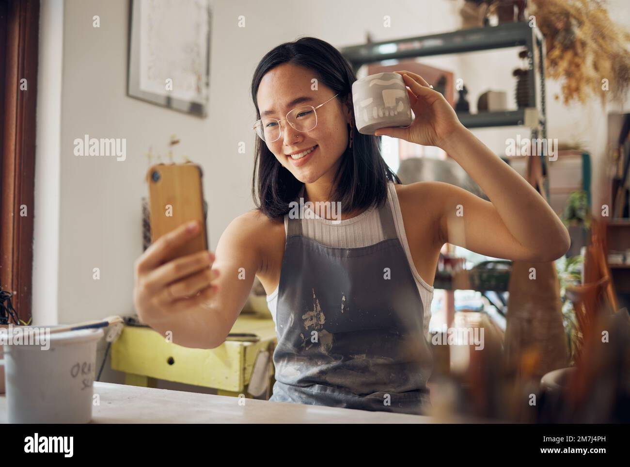 Artist woman, pottery and selfie with smile, design and product in ...