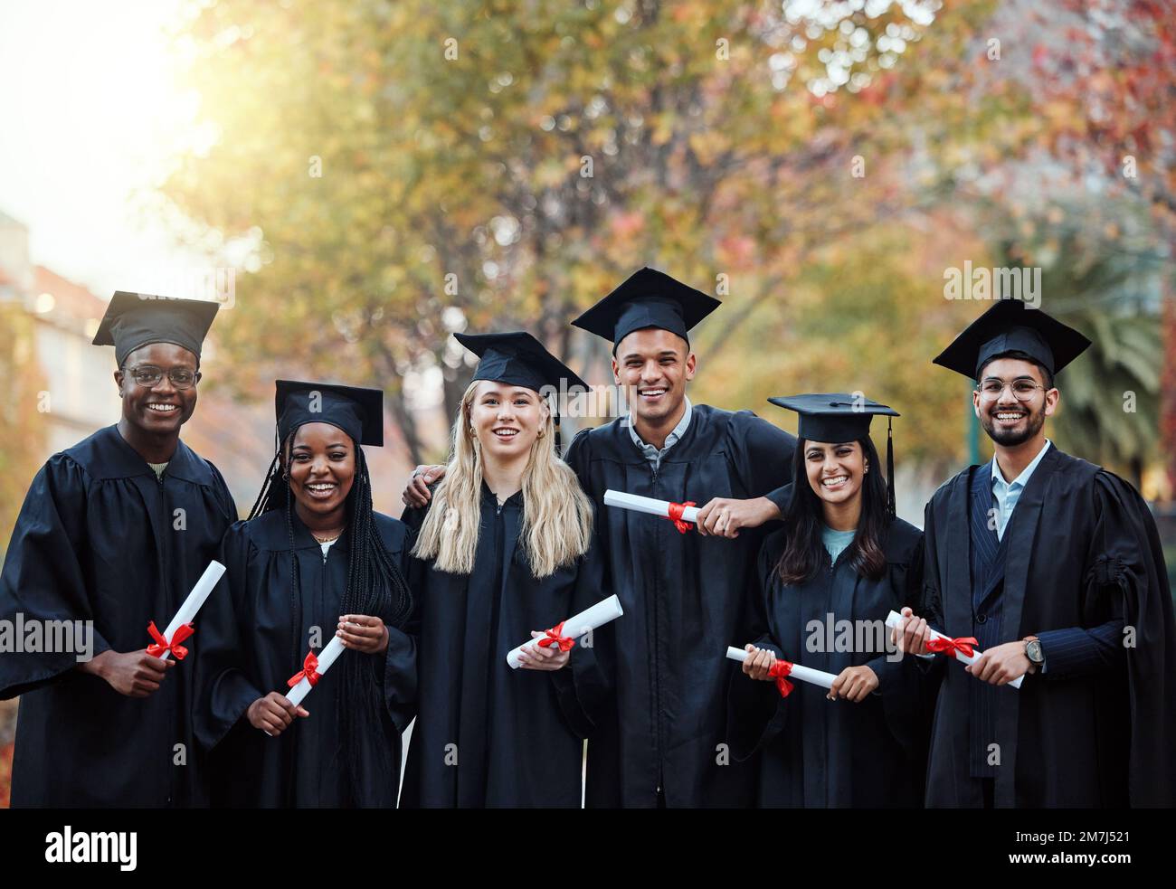 Success, graduation and portrait of friends with a diploma for ...