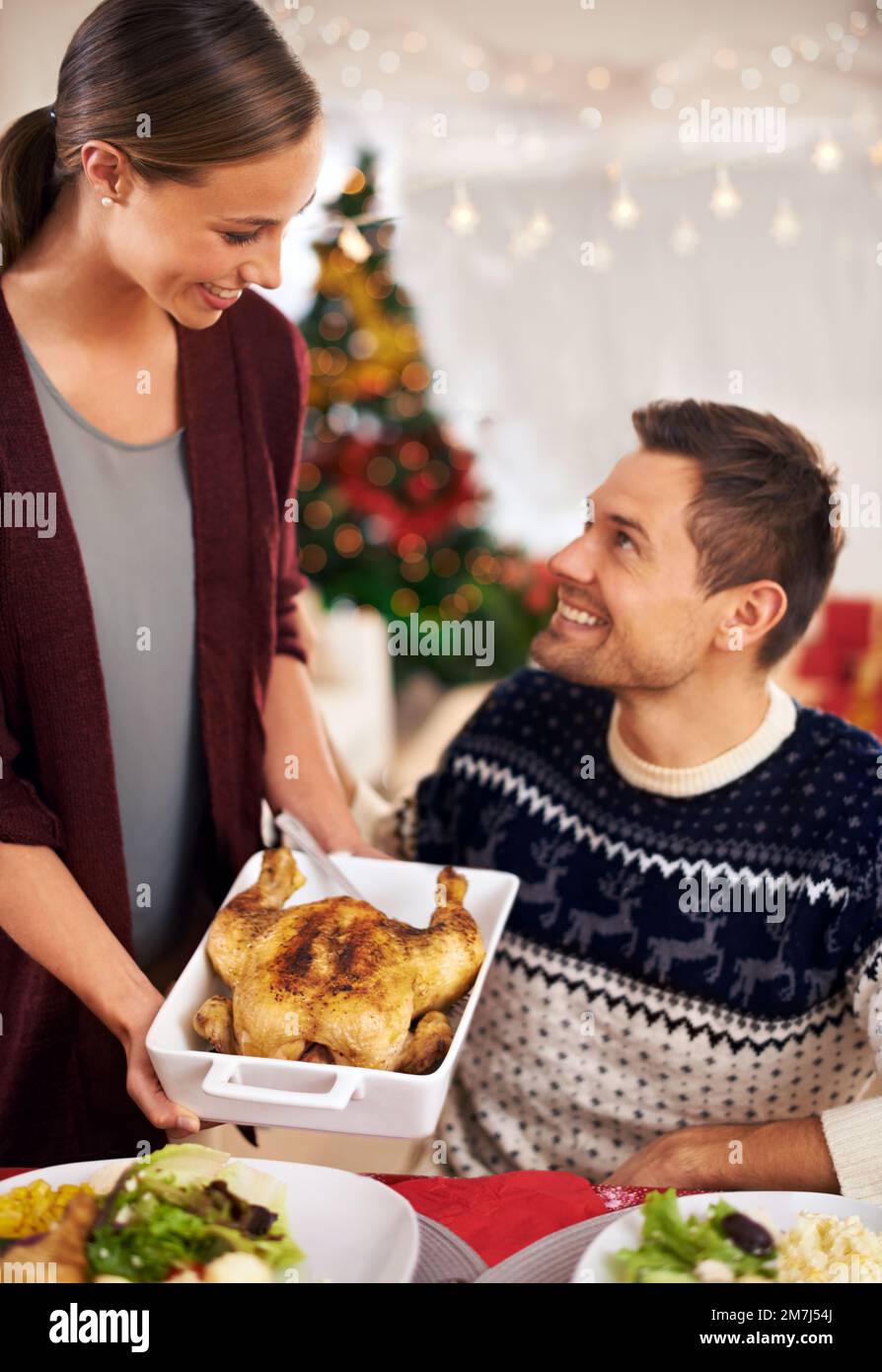 Its time for a Christmas feast. a young couple eating Christmas dinner ...