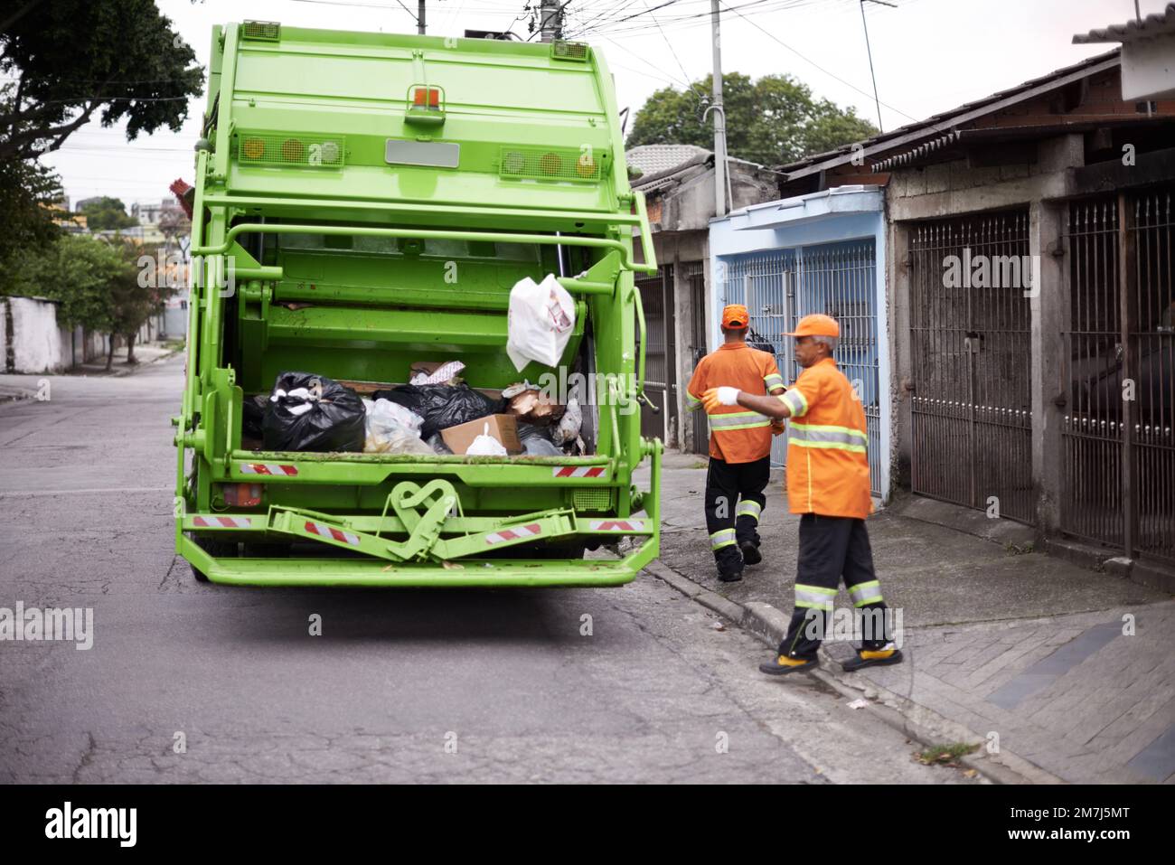 Garbage collection day. a garbage collection team at work Stock Photo ...