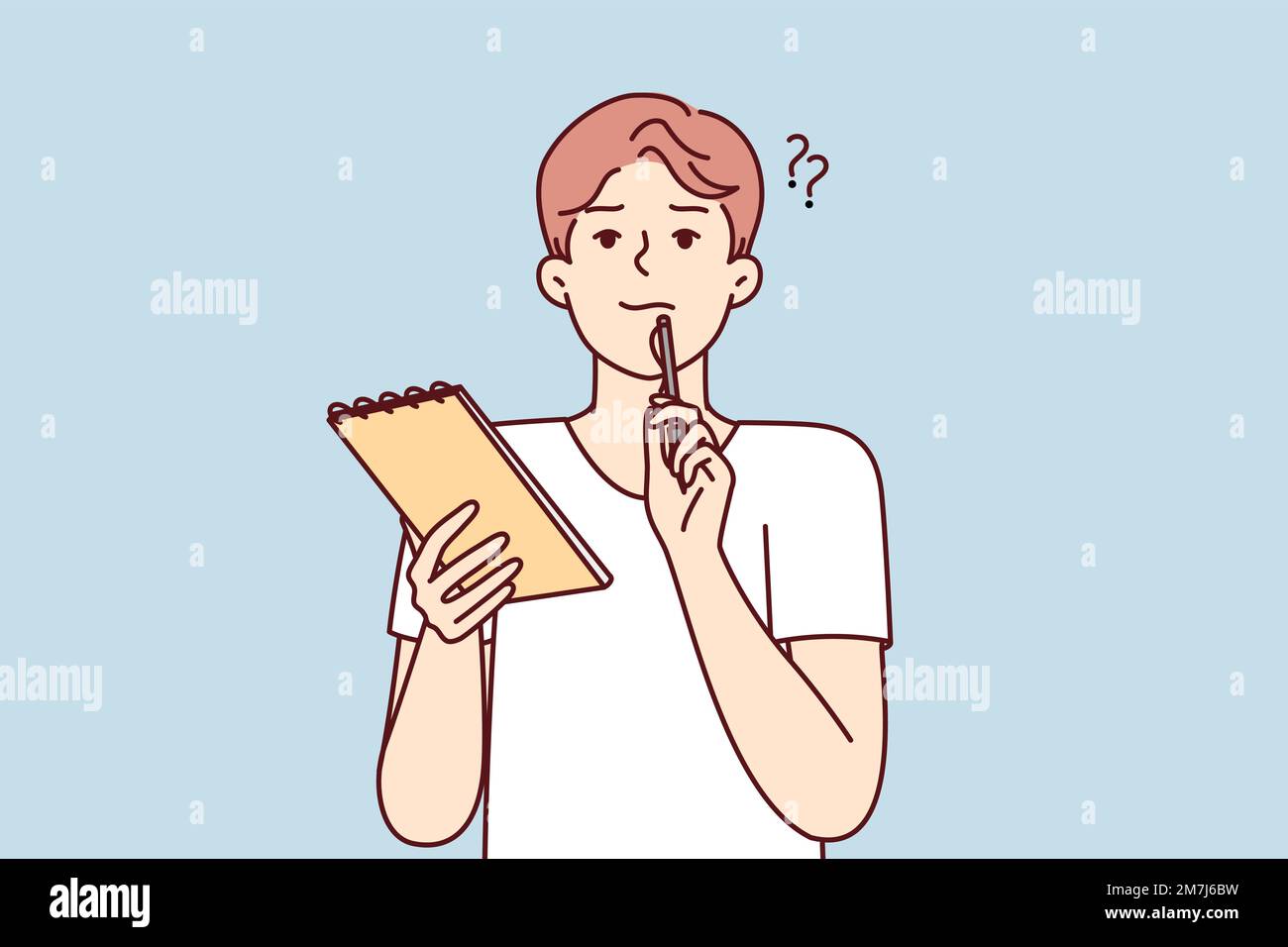 Positive thoughtful man with notebook in hand puts pen to face while ...