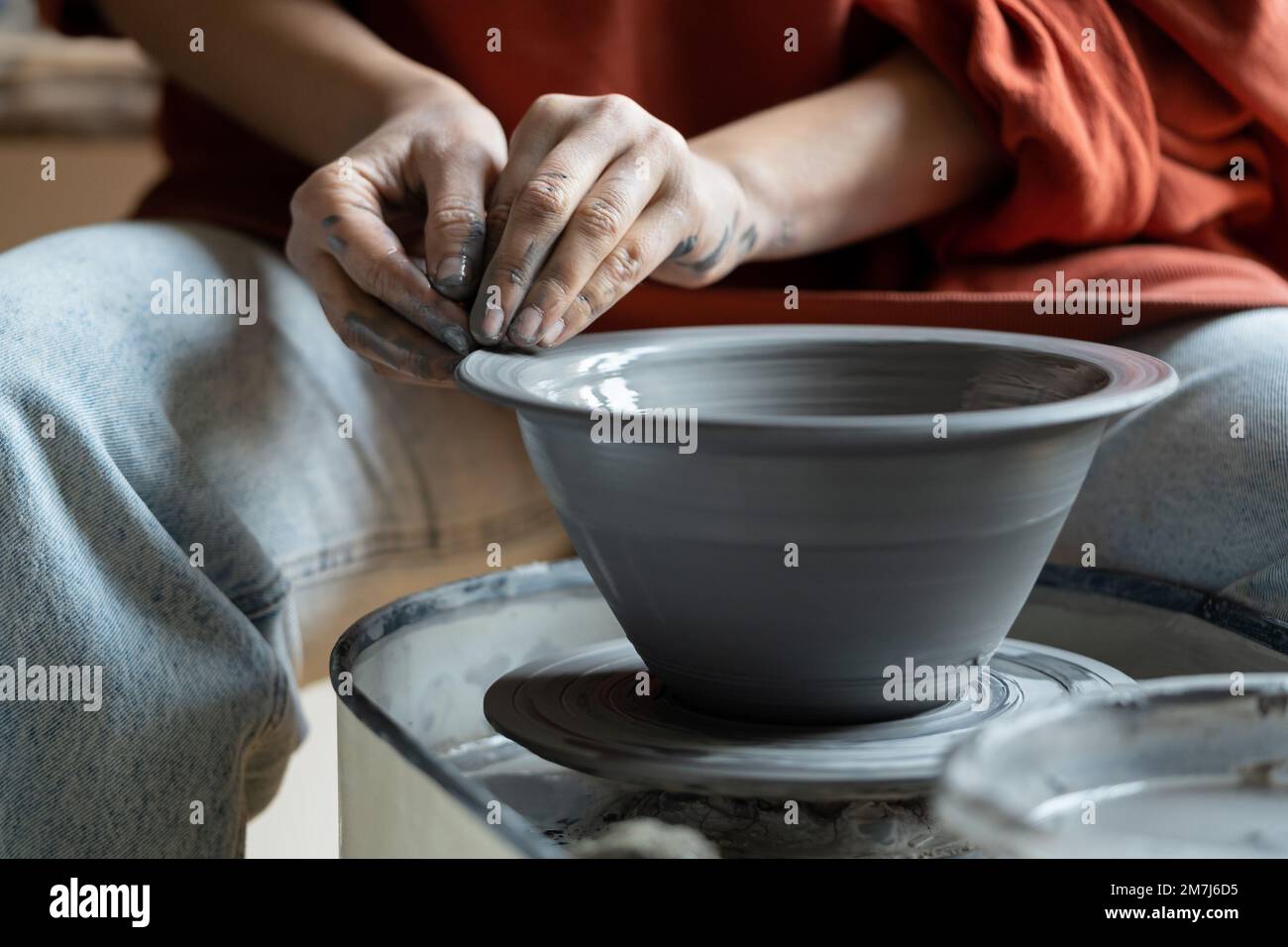Hands of creative woman sculpture working with potter wheel during ...