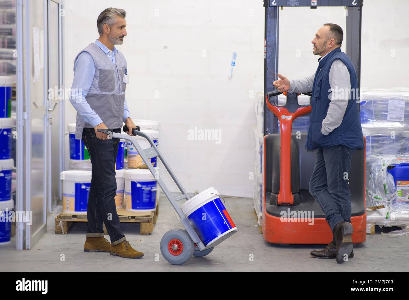 carrying paint in a factory Stock Photo - Alamy
