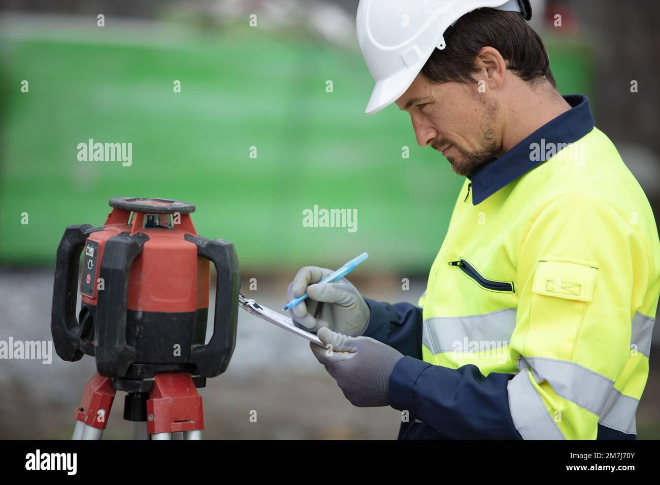 land surveyor at work on construction site Stock Photo - Alamy