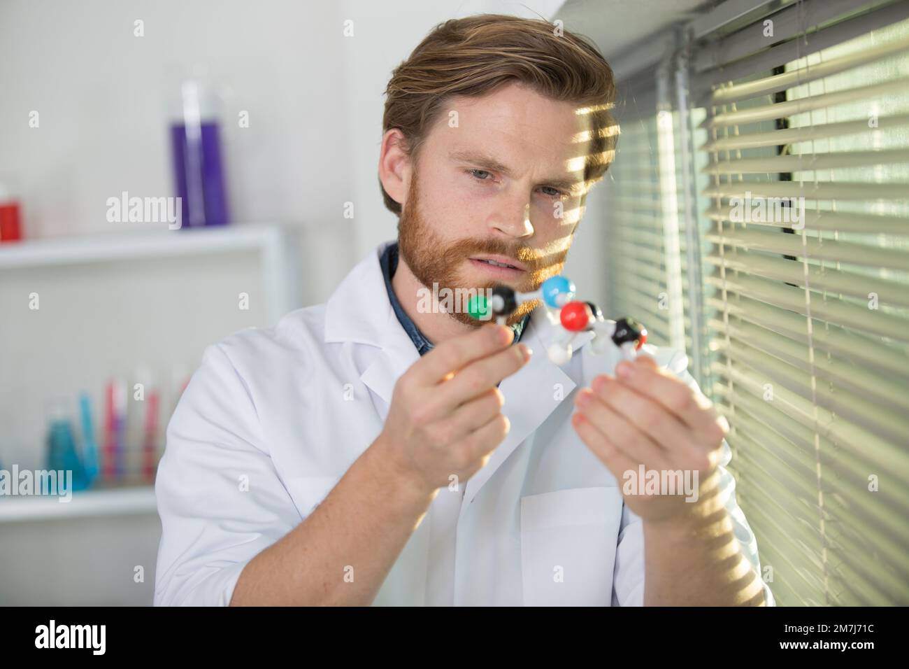 researcher with a white lab coat holding a molecular model Stock Photo ...