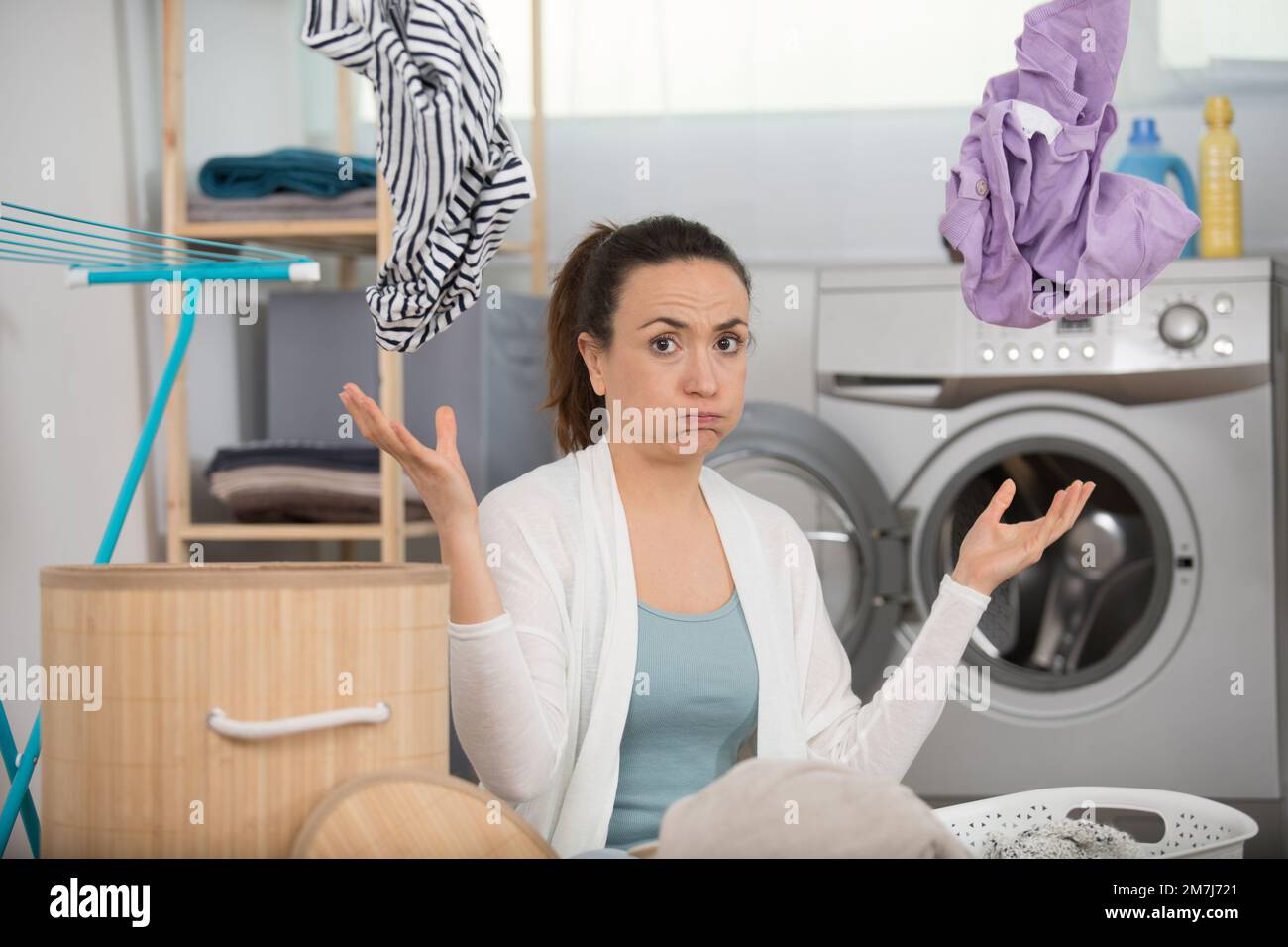 frustrated woman throwing laundry into the air Stock Photo - Alamy