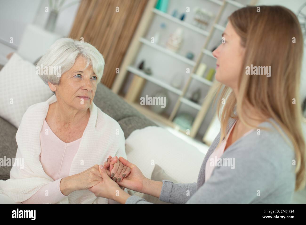 young woman talk with worried elderly mom Stock Photo - Alamy
