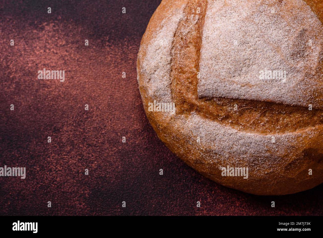 Beautiful delicious freshly baked round shaped white bread on a dark ...