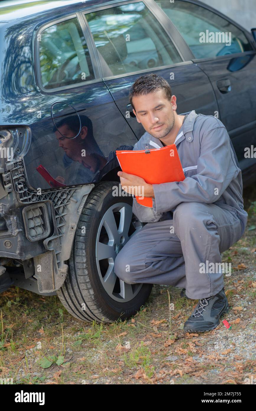 a mechanic is with folder Stock Photo - Alamy