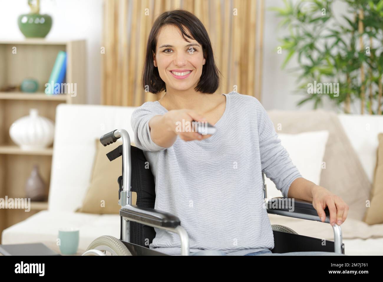 disabled lady using remote control Stock Photo - Alamy