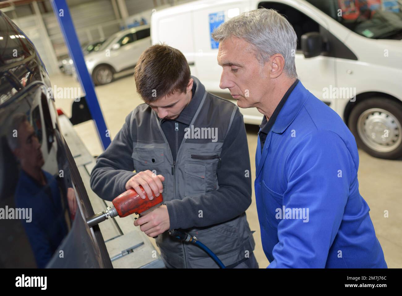 student with instructor repairing a car during apprenticeship Stock Photo - Alamy