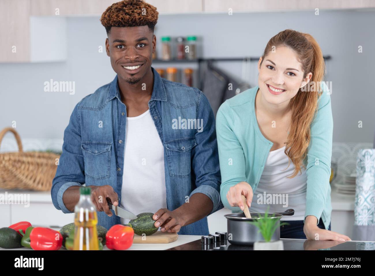 two lovely mixed people together cooking healthy food Stock Photo - Alamy