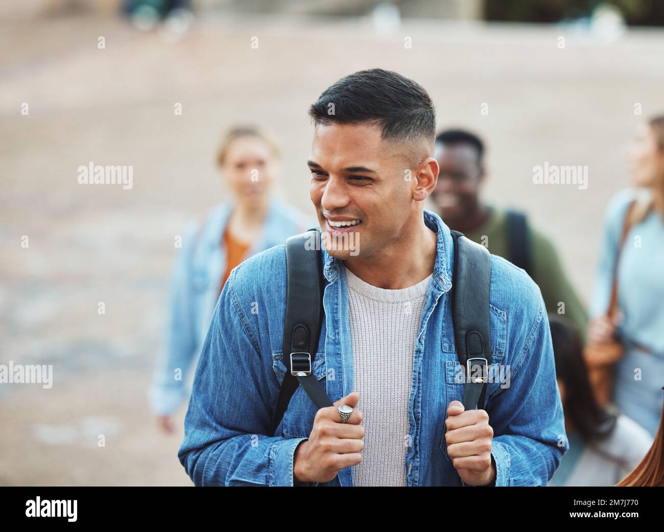 Laughing man, walking or students on university campus, college or ...