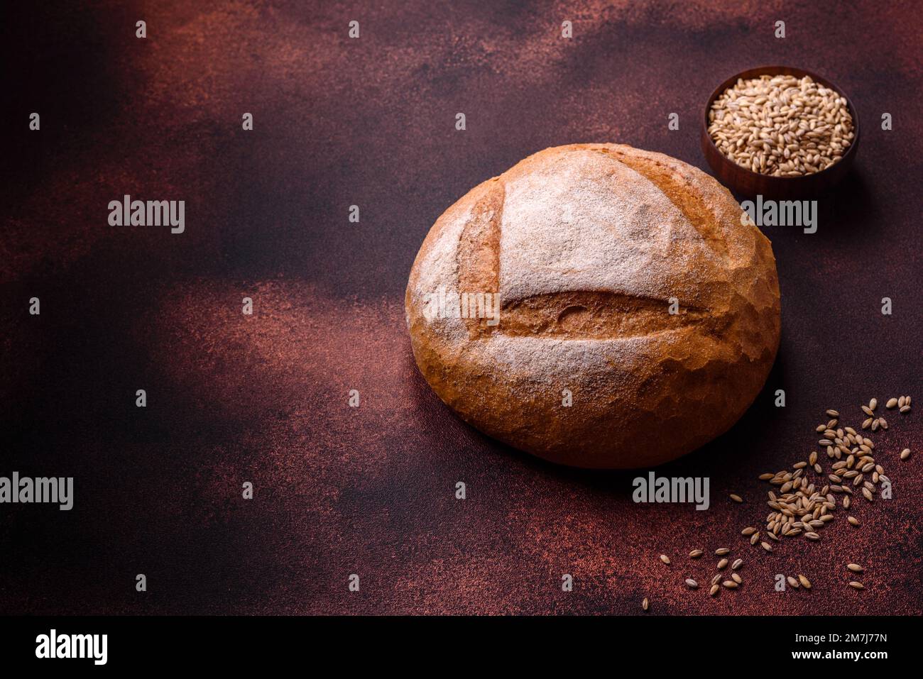 Beautiful delicious freshly baked round shaped white bread on a dark ...