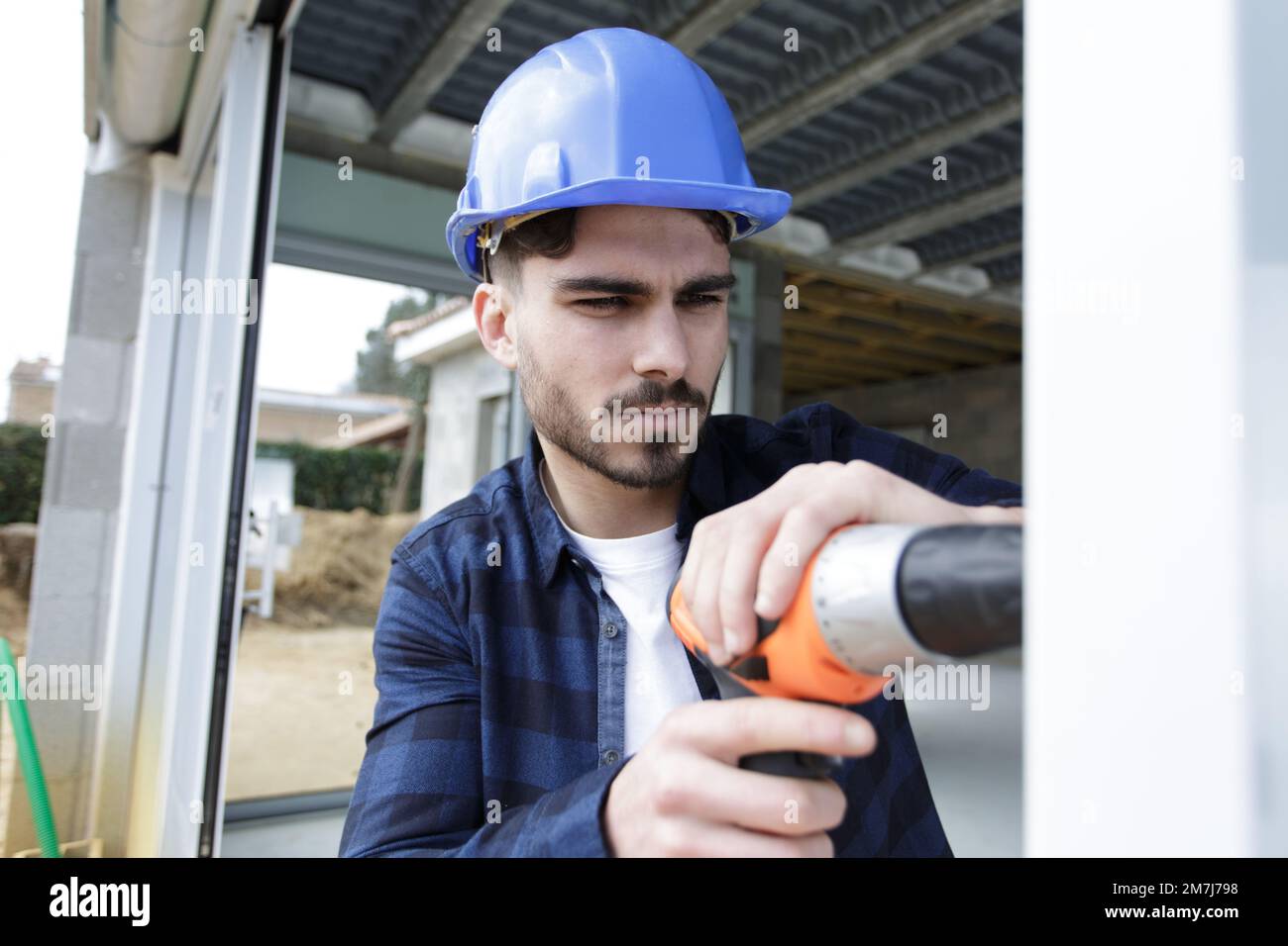 serious man is drilling a wall Stock Photo - Alamy