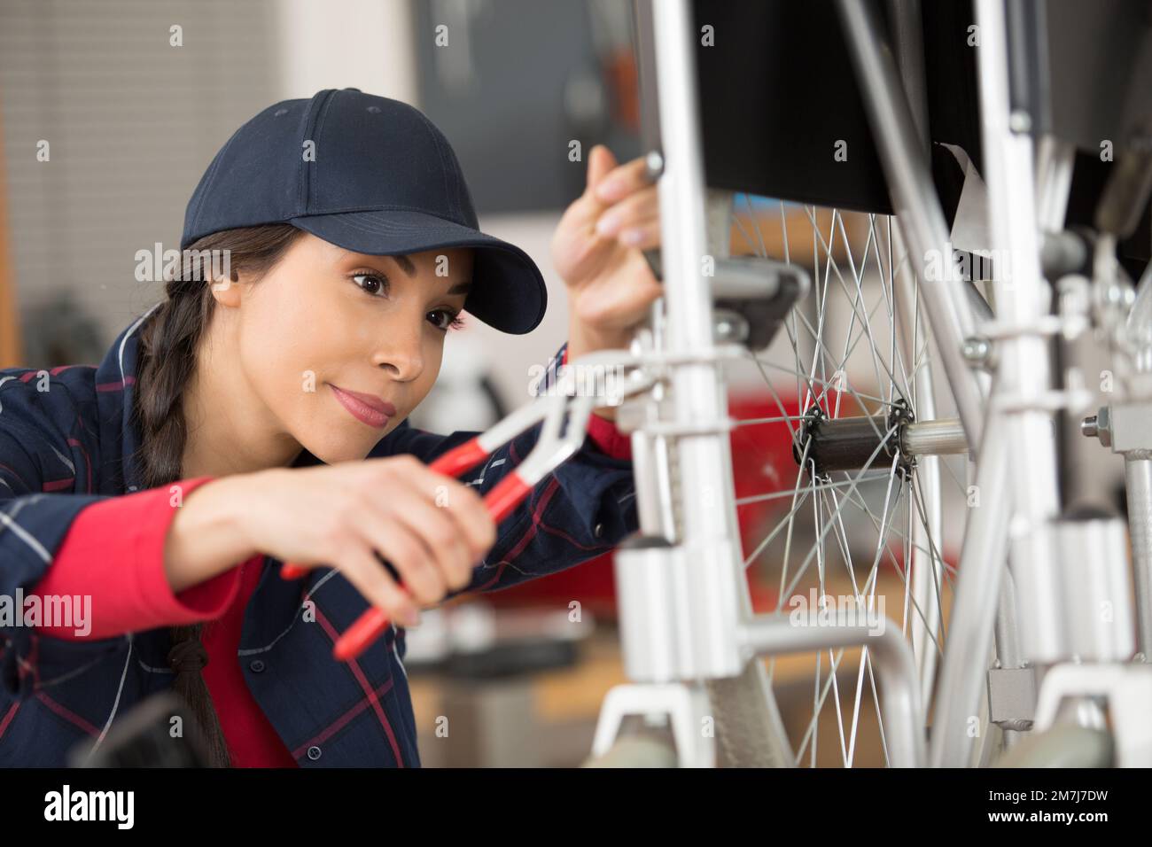 female mechanic maintaining wheelchair brakes Stock Photo - Alamy