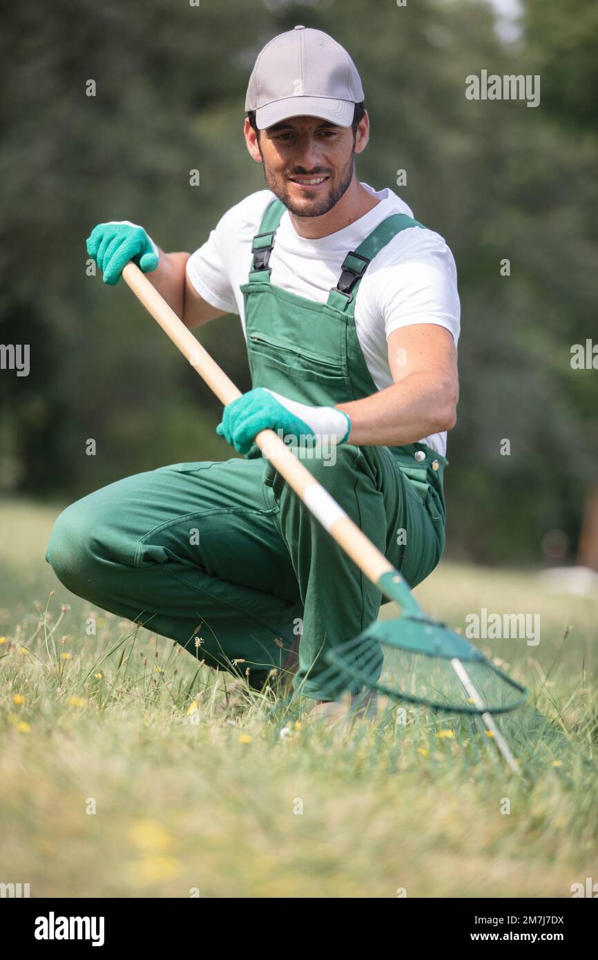 Old man raking grass hi-res stock photography and images - Alamy