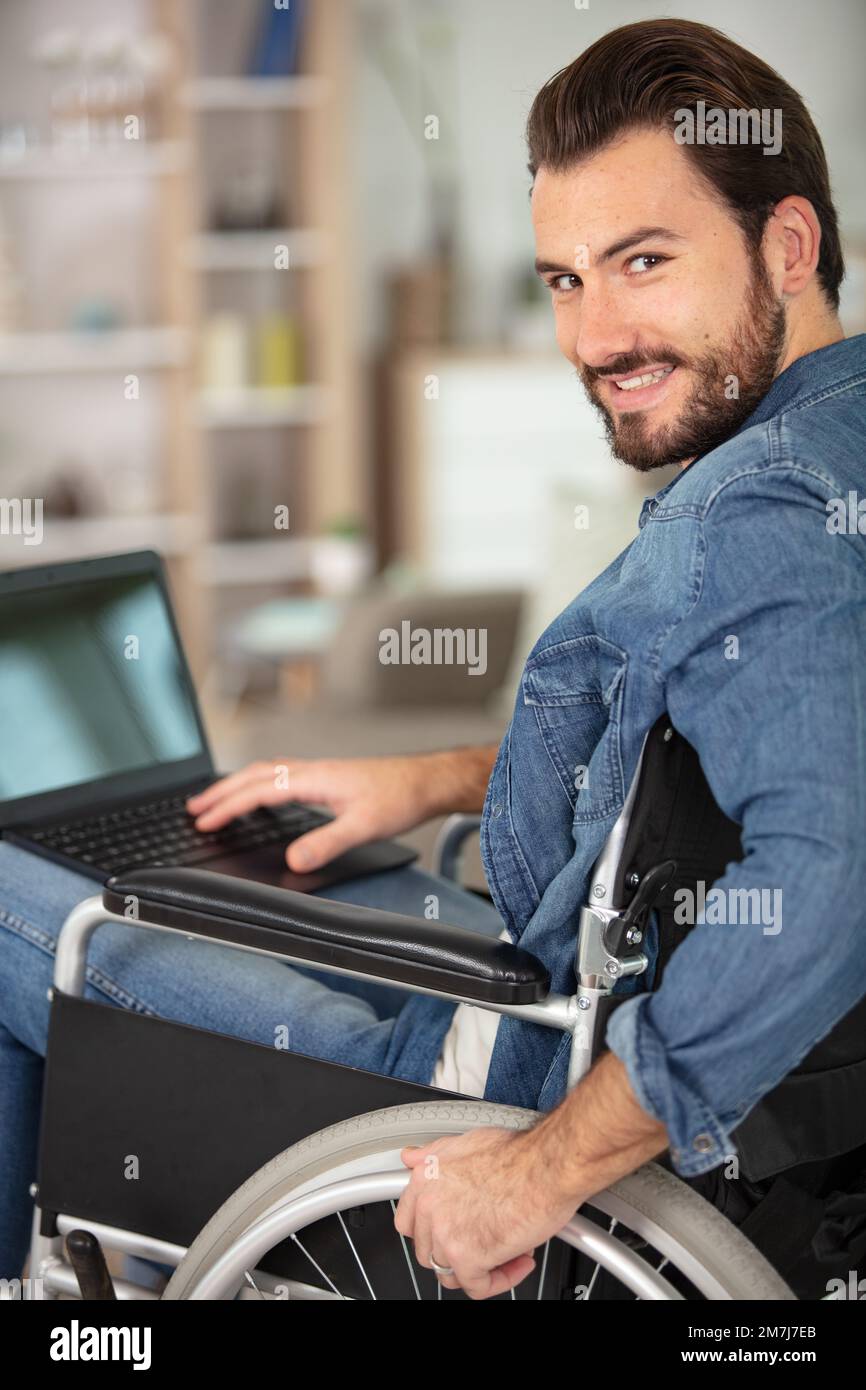 a young disabled man works at home Stock Photo - Alamy
