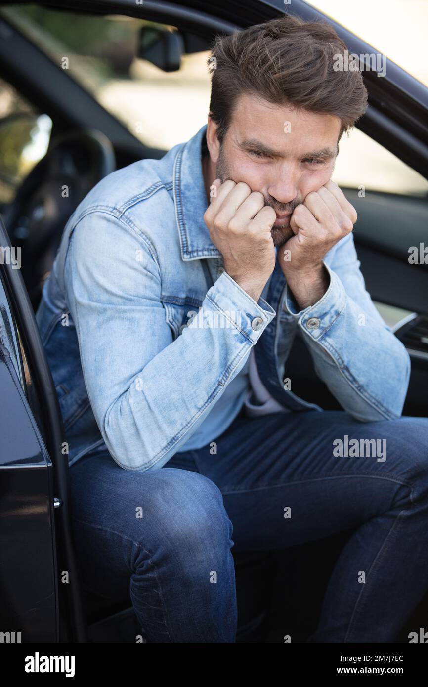 worried man sat in his parked car Stock Photo - Alamy