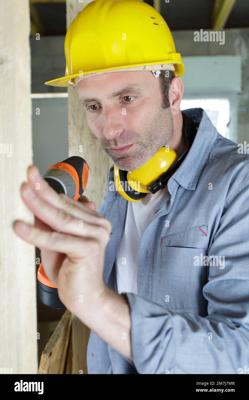 man drilling the window with impact drill Stock Photo - Alamy