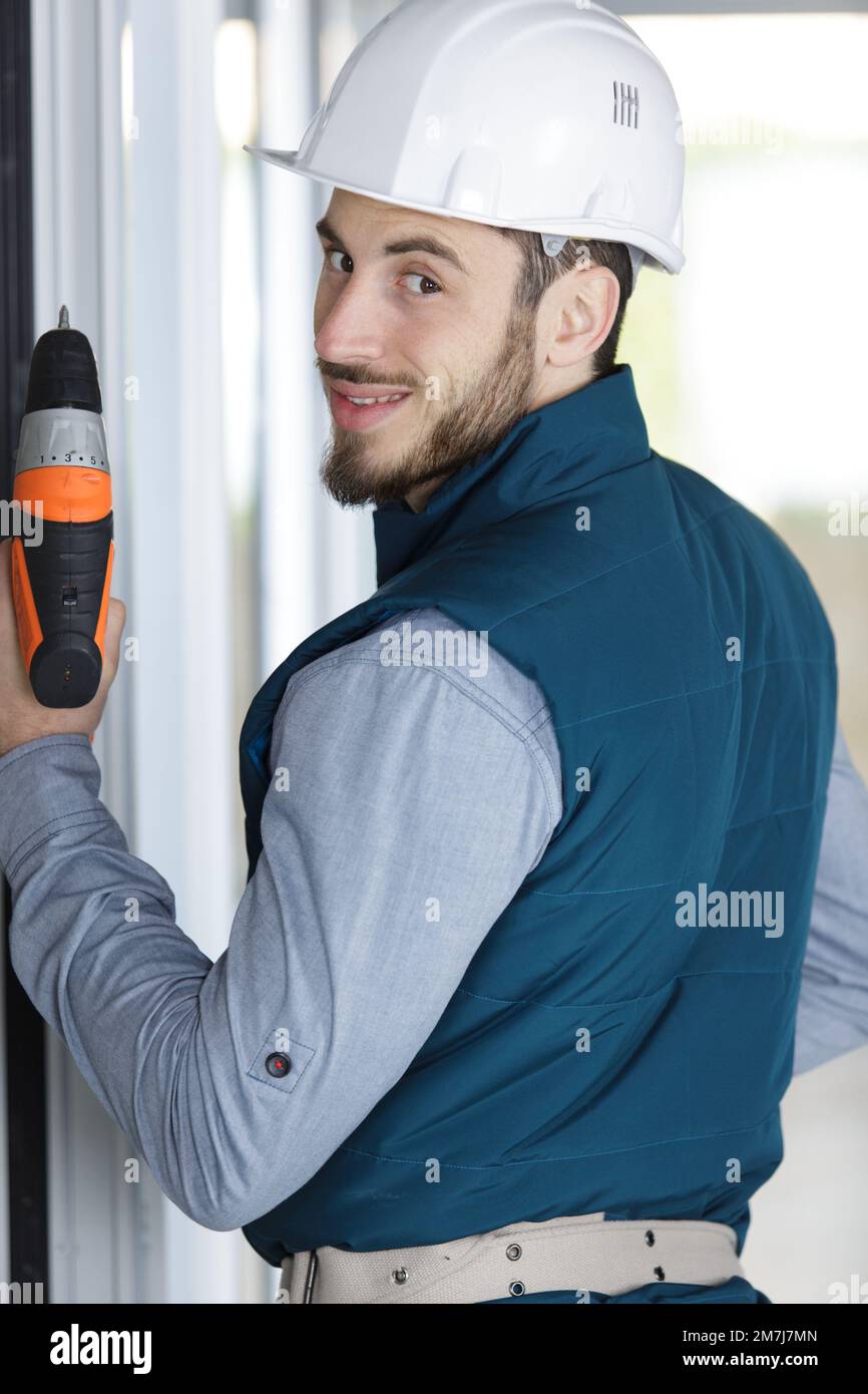 male builder with drill Stock Photo - Alamy