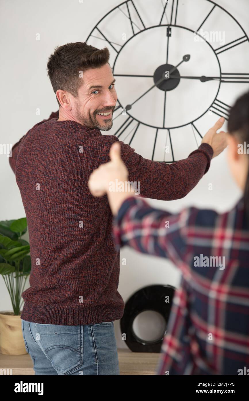Couple hanging clock in hi-res stock photography and images - Alamy